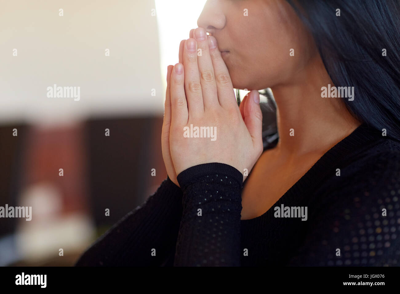 close up of sad woman praying god in church Stock Photo - Alamy