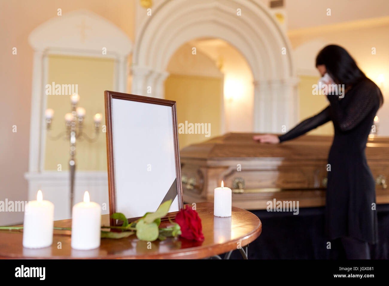 photo frame and woman crying at coffin at funeral Stock Photo - Alamy