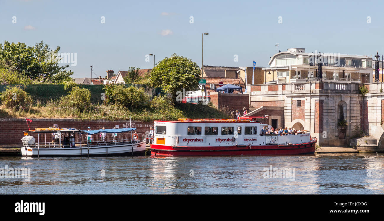 Two small passenger boats near Hampton Court Bridge, tied up available ...