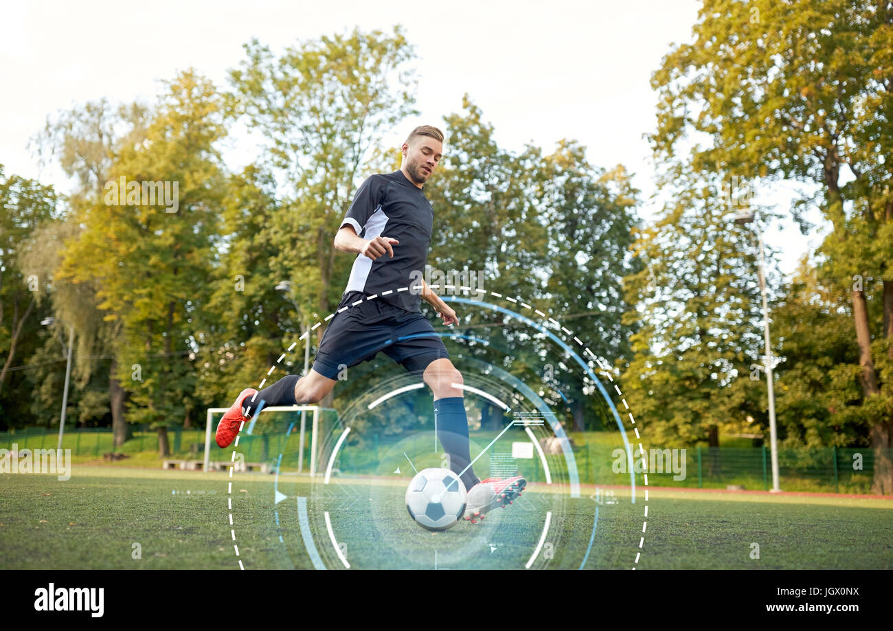soccer player playing with ball on football field Stock Photo - Alamy