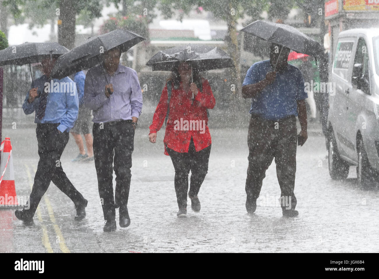 London, UK. 11th July, 2017. UK Weather: Rain in London. Pedestrains ...