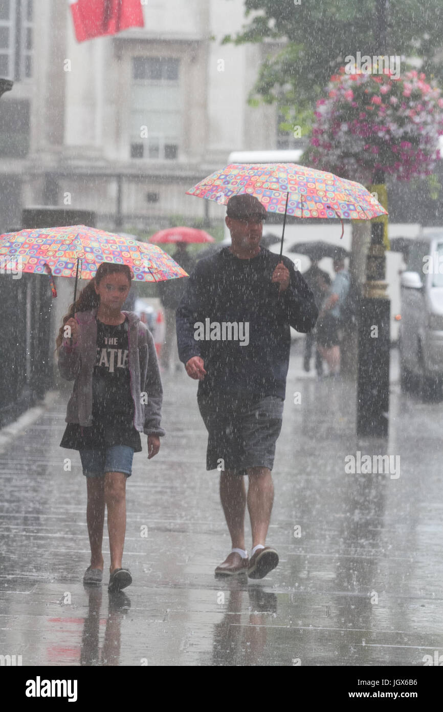 London, UK. 11th July, 2017. UK Weather: Rain in London. Pedestrains ...