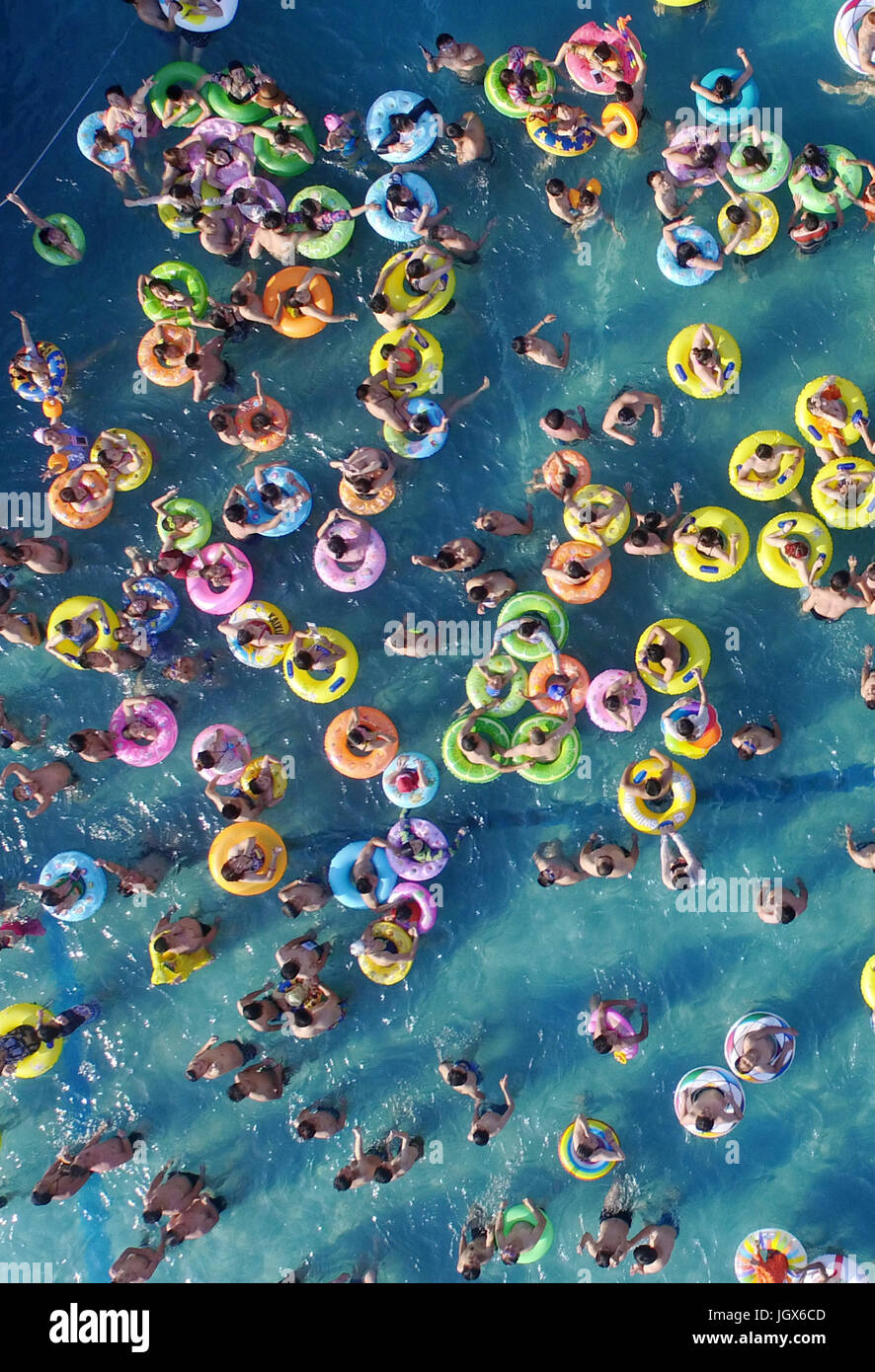 Yangzhou. 11th July, 2017. Tourists play in the water at a water park ...