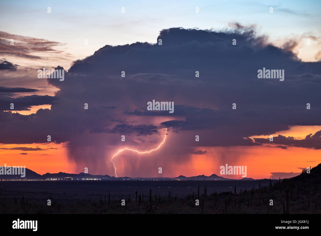 Dramatic monsoon thunderstorm clouds and lightning strike at sunset in ...