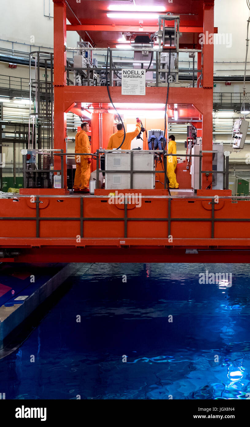 Workers in protective suits carry out inspection work over the opened ...