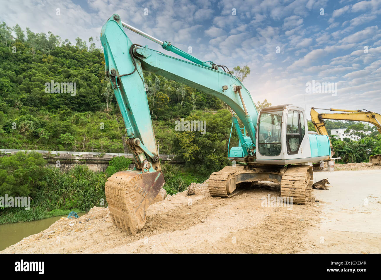 Heavy earth mover with blue sky in the background Stock Photo - Alamy