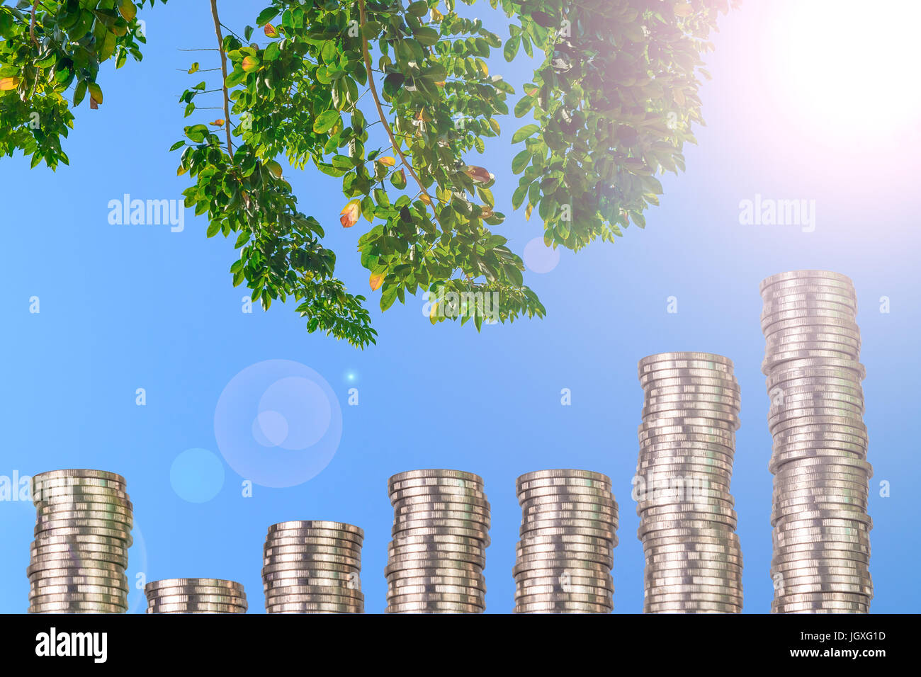 Savings, columns of coins, piles of coins arranged as a graph on blue ...