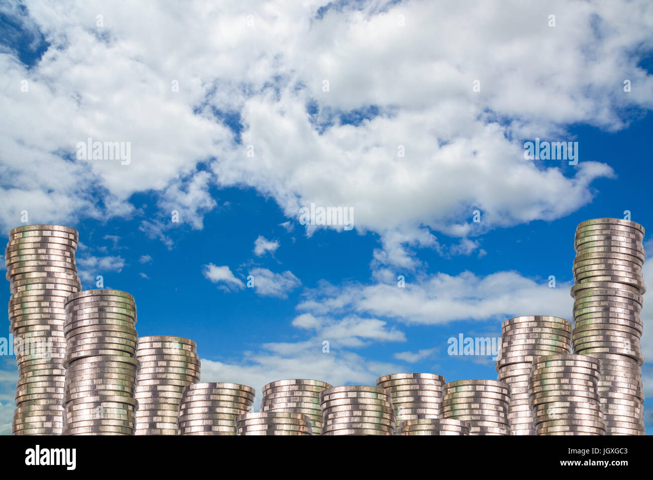 Savings, columns of coins, piles of coins arranged as a graph on blue ...