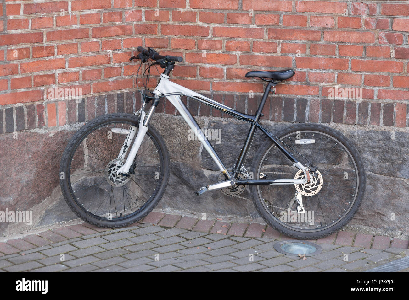 mountain bike near bricks wall on cobblestone Stock Photo - Alamy