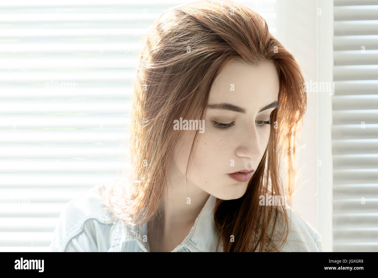 sensual beautiful woman sitting at window with blinds in sunlight Stock Photo - Alamy