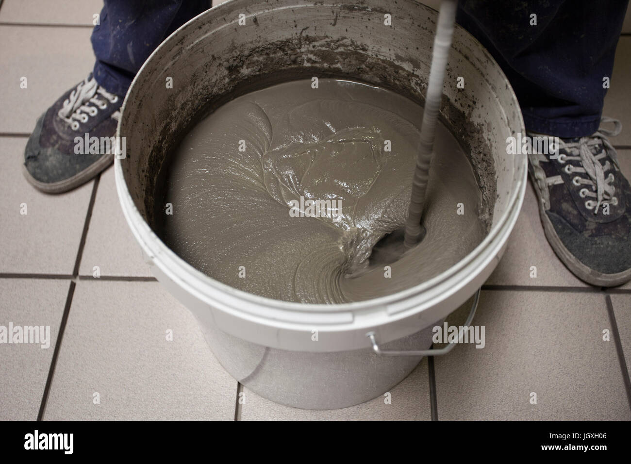 Preparation of tile adhesive with bucket stirrer Stock Photo - Alamy