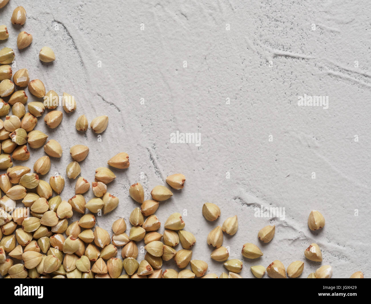 Raw green buckwheat on gray concrete background Healthy food and diet ...