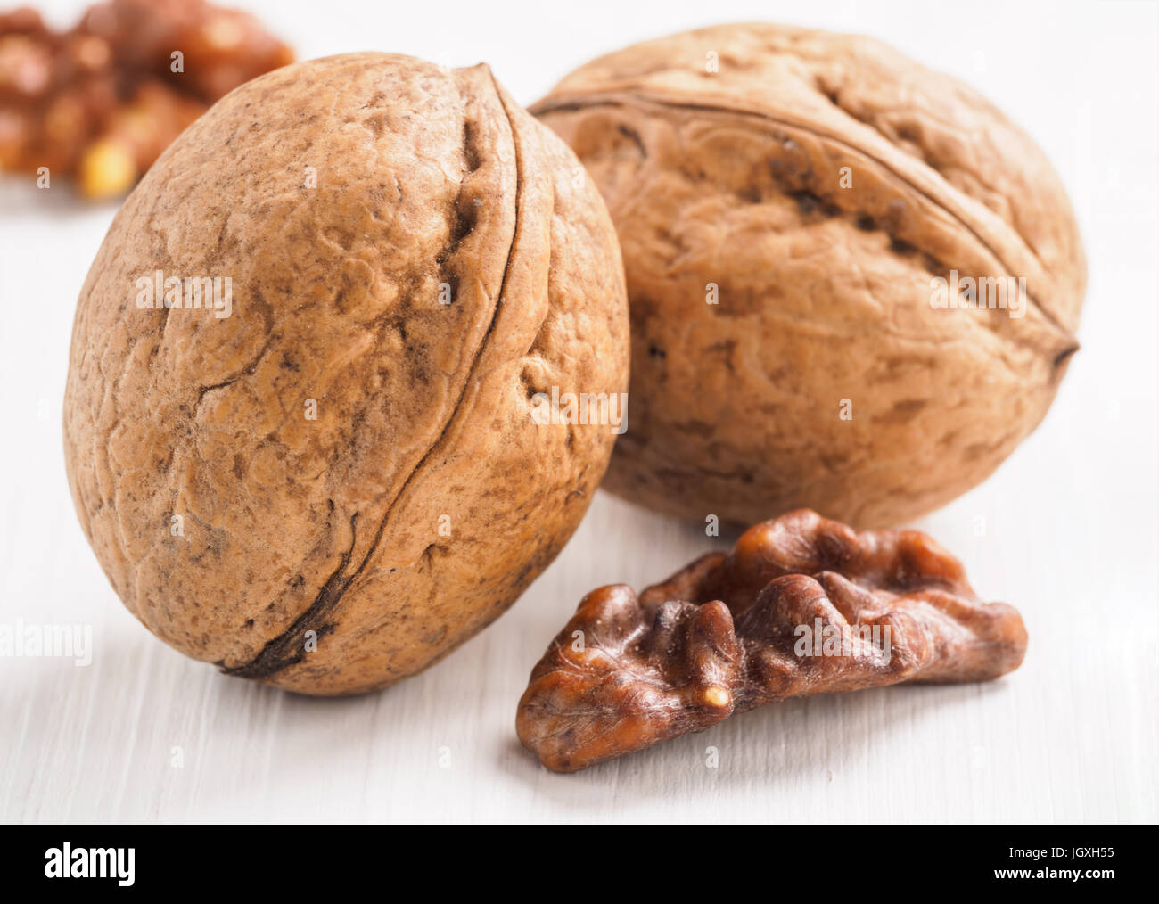 Close up view on inshell walnut on white wooden background Stock Photo ...