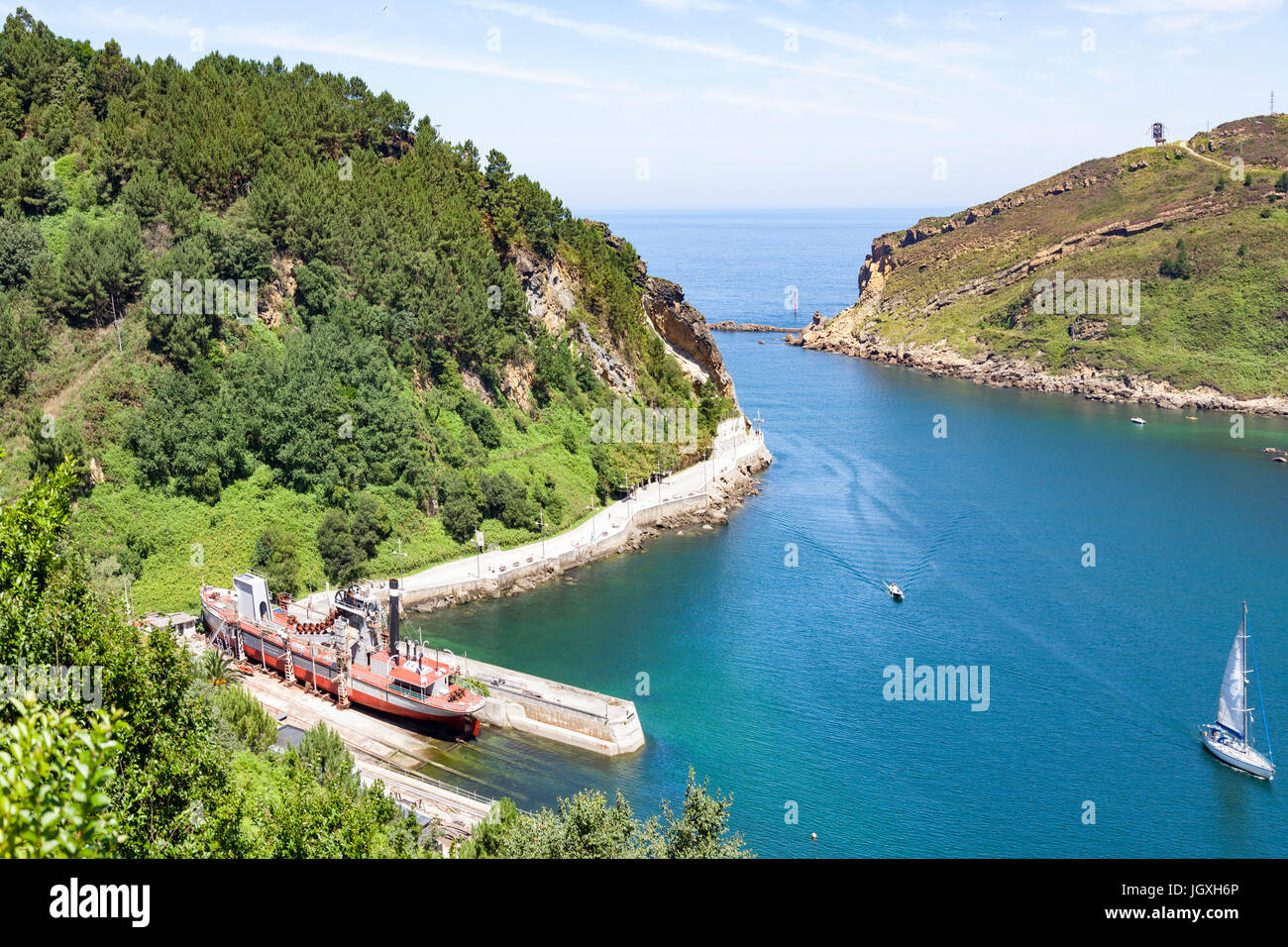A bucket dredging ship in dry dock in the fjord of Pasajes (Guipuzkoa ...