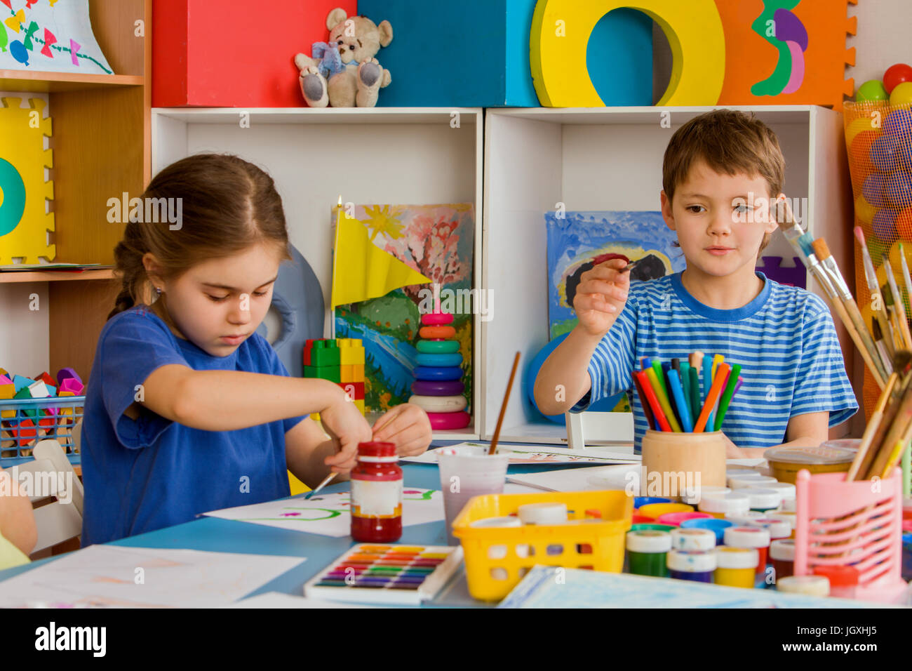 Small students girl and boy painting in art school class Stock Photo ...