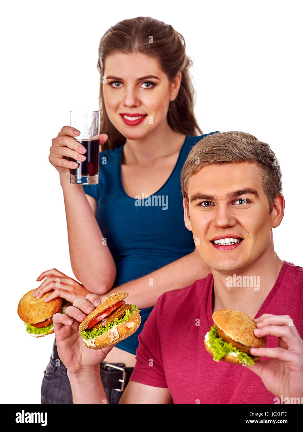 Couple eating fast food. Man and woman treat hamburger Stock Photo - Alamy