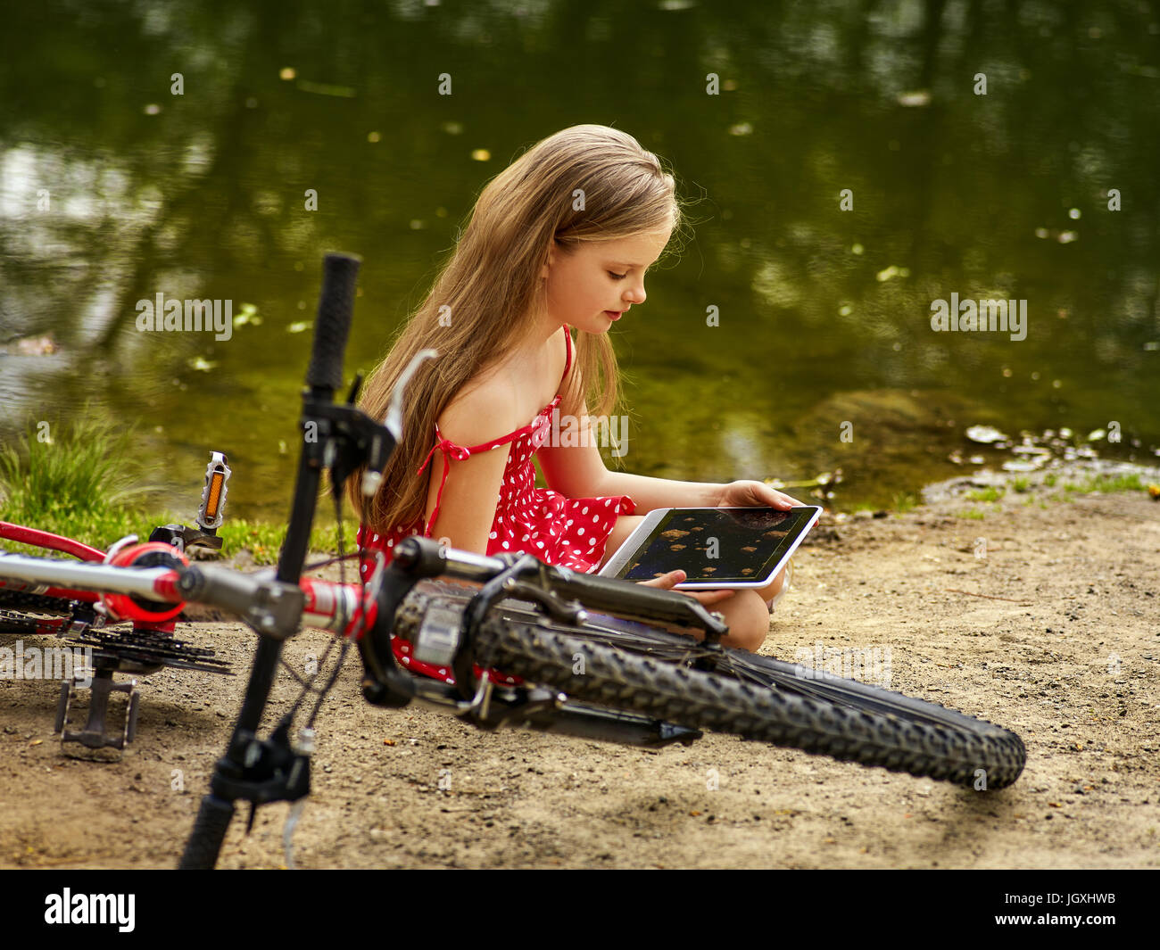 Bikes cycling girl. Girl has rest near bicycle into park Stock Photo ...