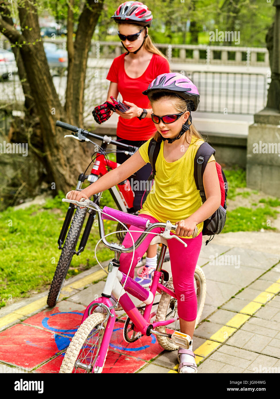 Family bike ride with rucksack cycling on bike lane Stock Photo - Alamy