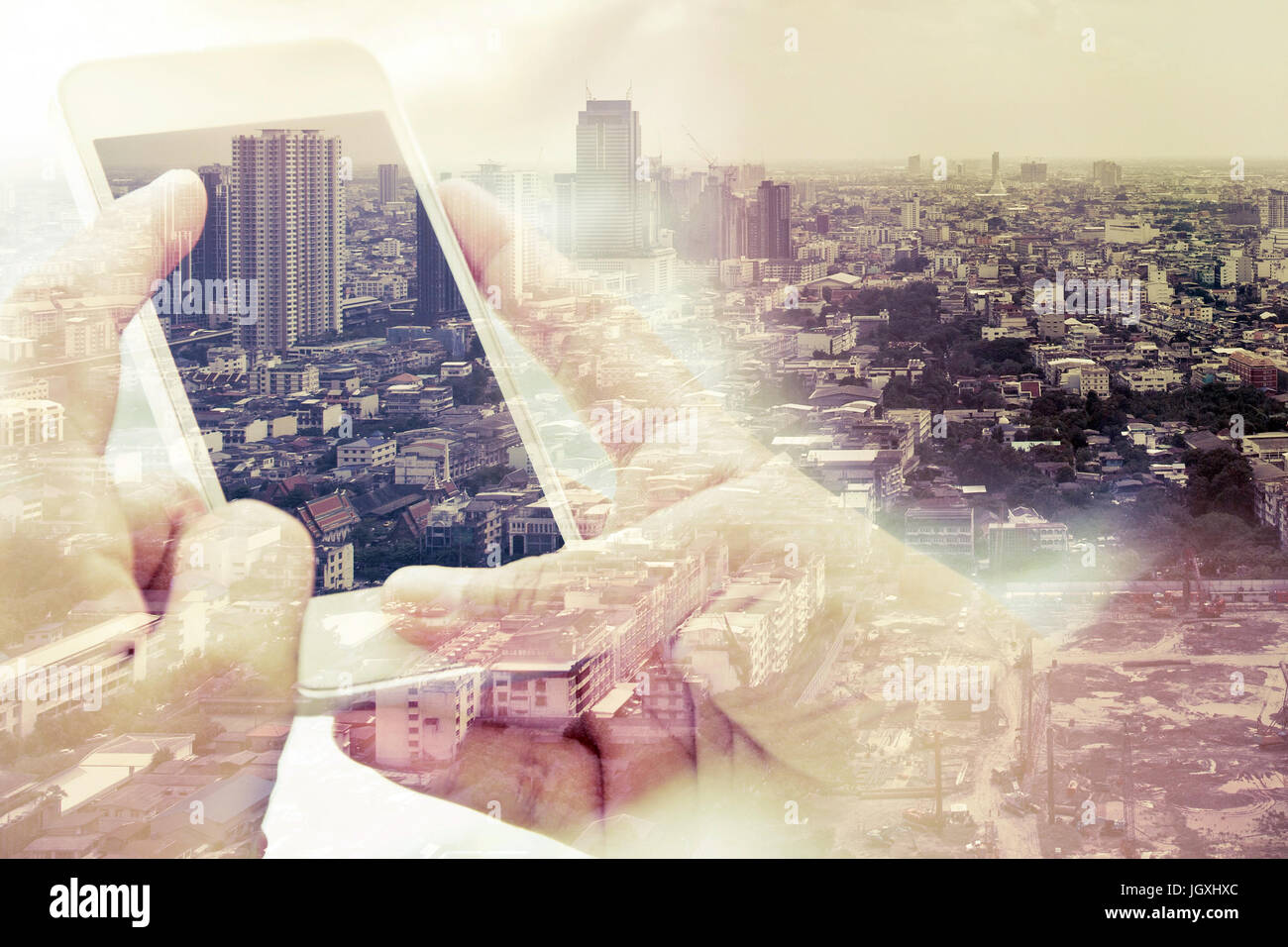 Double exposure image of smart phone with cityscape background ...