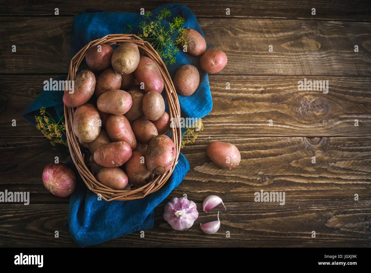 Summer still life of ripe potatoes on a wooden table Stock Photo - Alamy