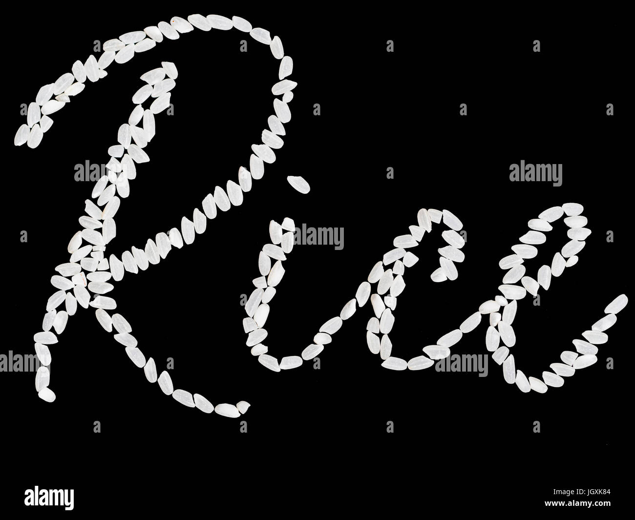 Word Rice made from raw grains, isolated on black background with ...