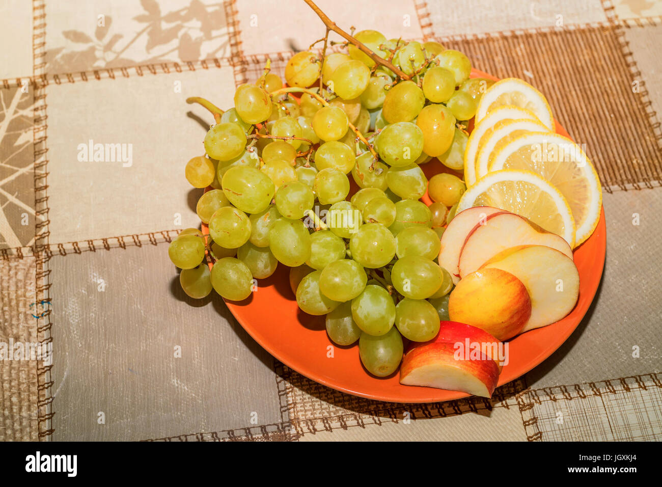 Fruit plate with grapes, apple and lemon Stock Photo - Alamy