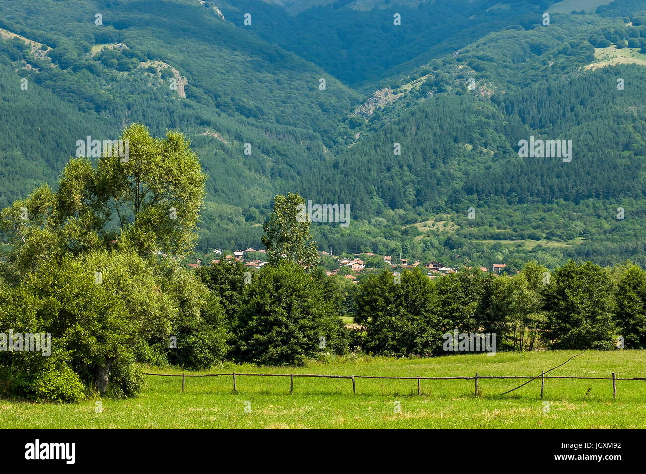 Scene with mountain glade, forest and residential district of bulgarian ...