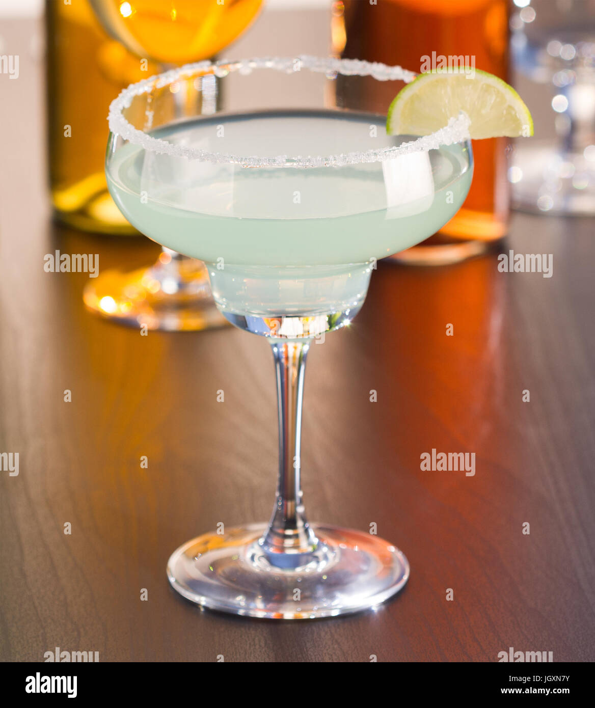 Tropical cocktail garnished with lime slice Stock Photo - Alamy