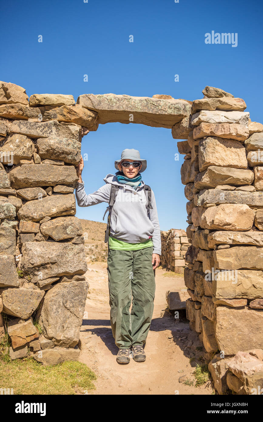 Tourist exploring the ancient mysterious Inca labyrinth-like settlement ...