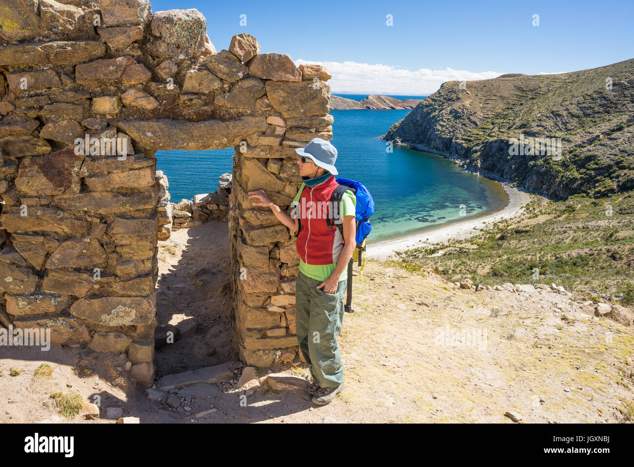 Tourist exploring the ancient mysterious Inca labyrinth-like settlement ...