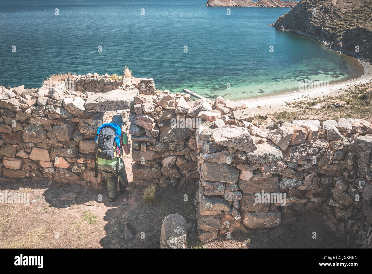 Tourist exploring the ancient mysterious Inca labyrinth-like settlement ...