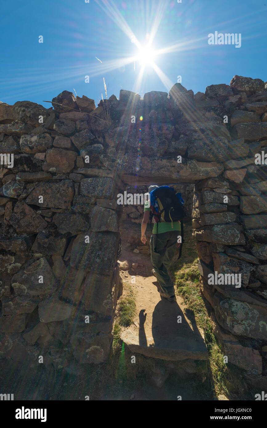 Tourist exploring the ancient mysterious Inca labyrinth-like settlement ...