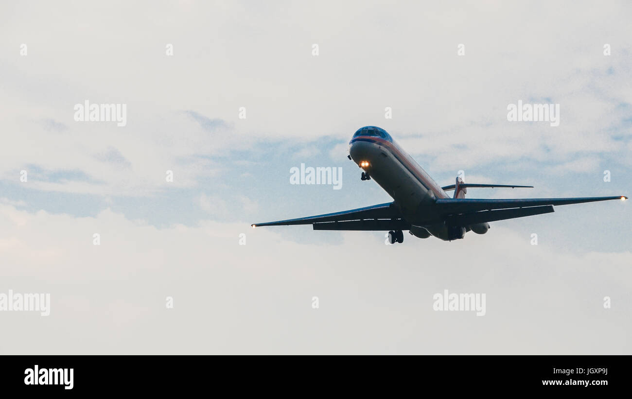 Airplane approaching runway to land at airport Stock Photo - Alamy