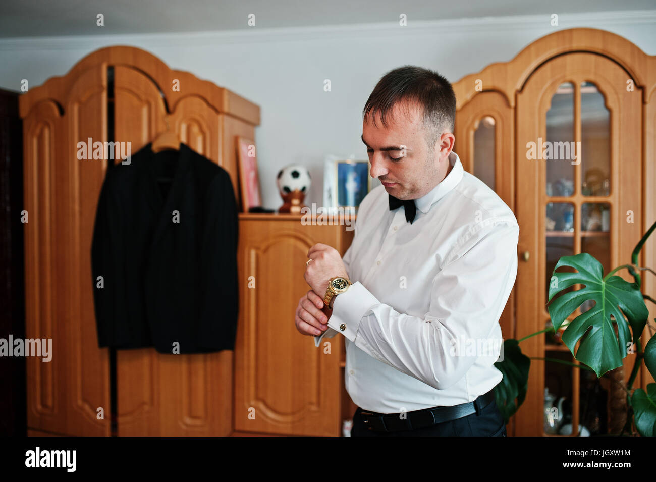 Handsome groom dressing up in his room for his wedding ceremony Stock ...