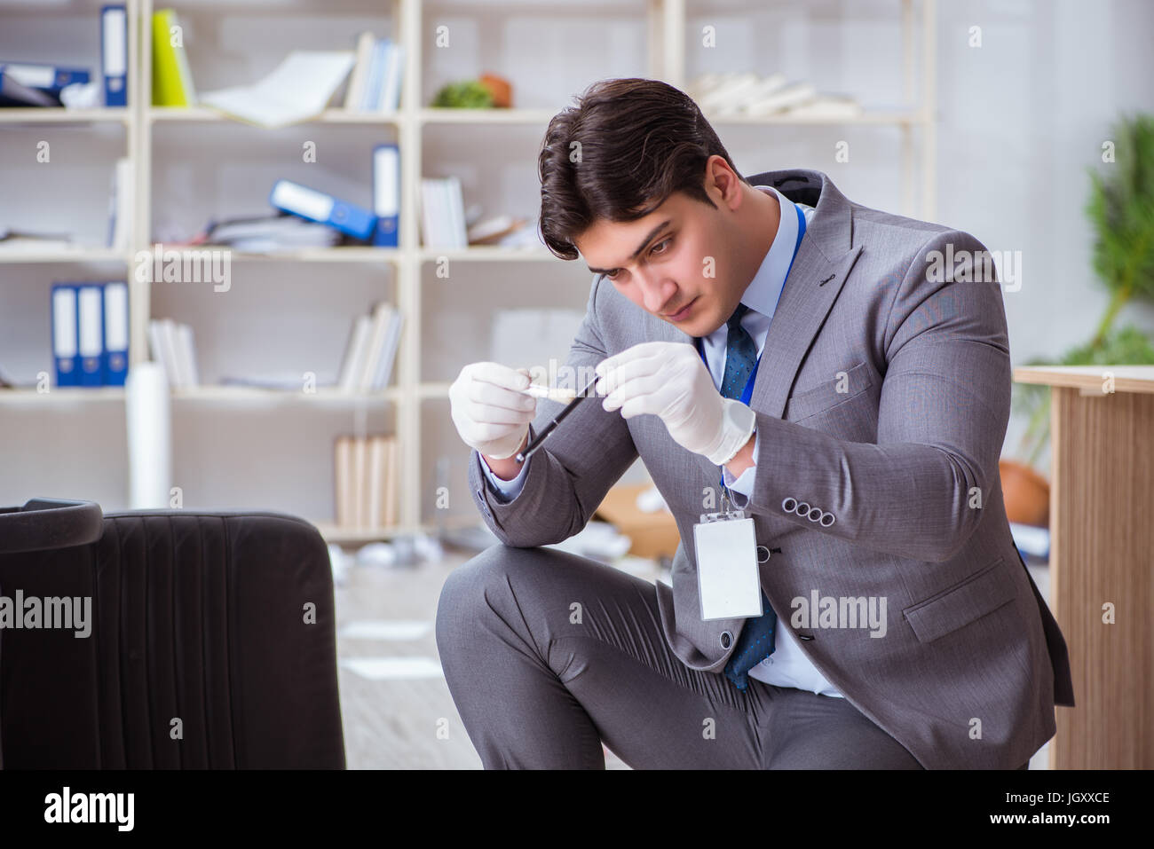 Young man during crime investigation in office Stock Photo - Alamy