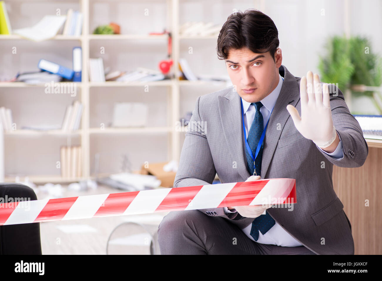 Young man during crime investigation in office Stock Photo - Alamy