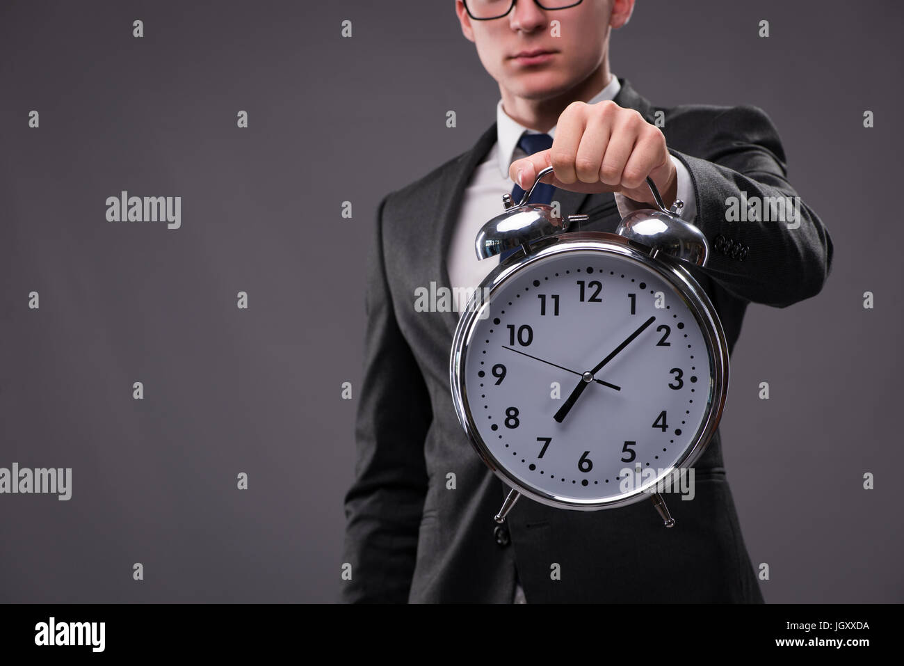 Businessman in time management concept Stock Photo - Alamy