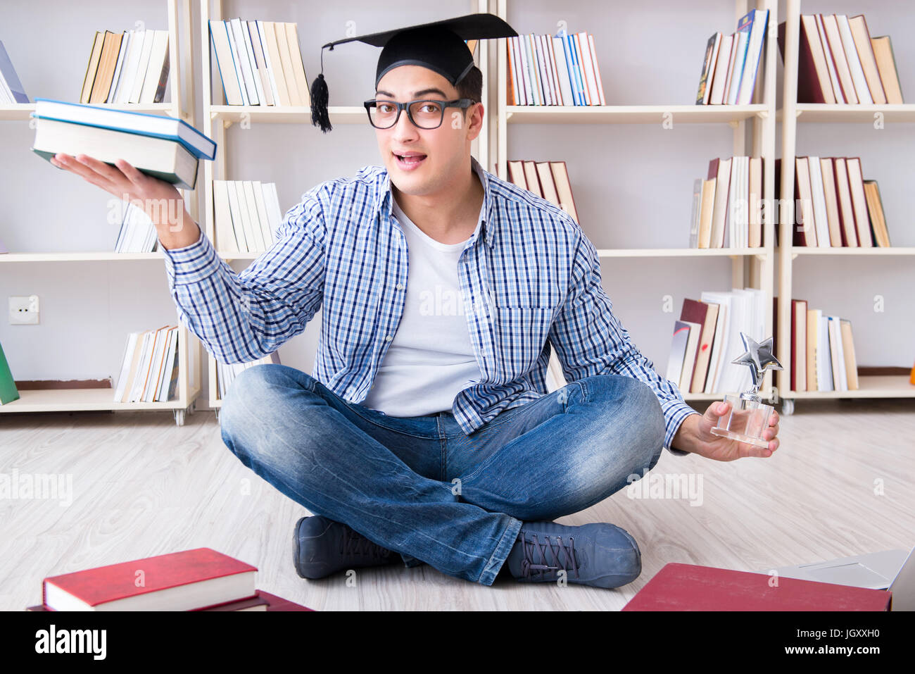 Young student studying with books Stock Photo - Alamy