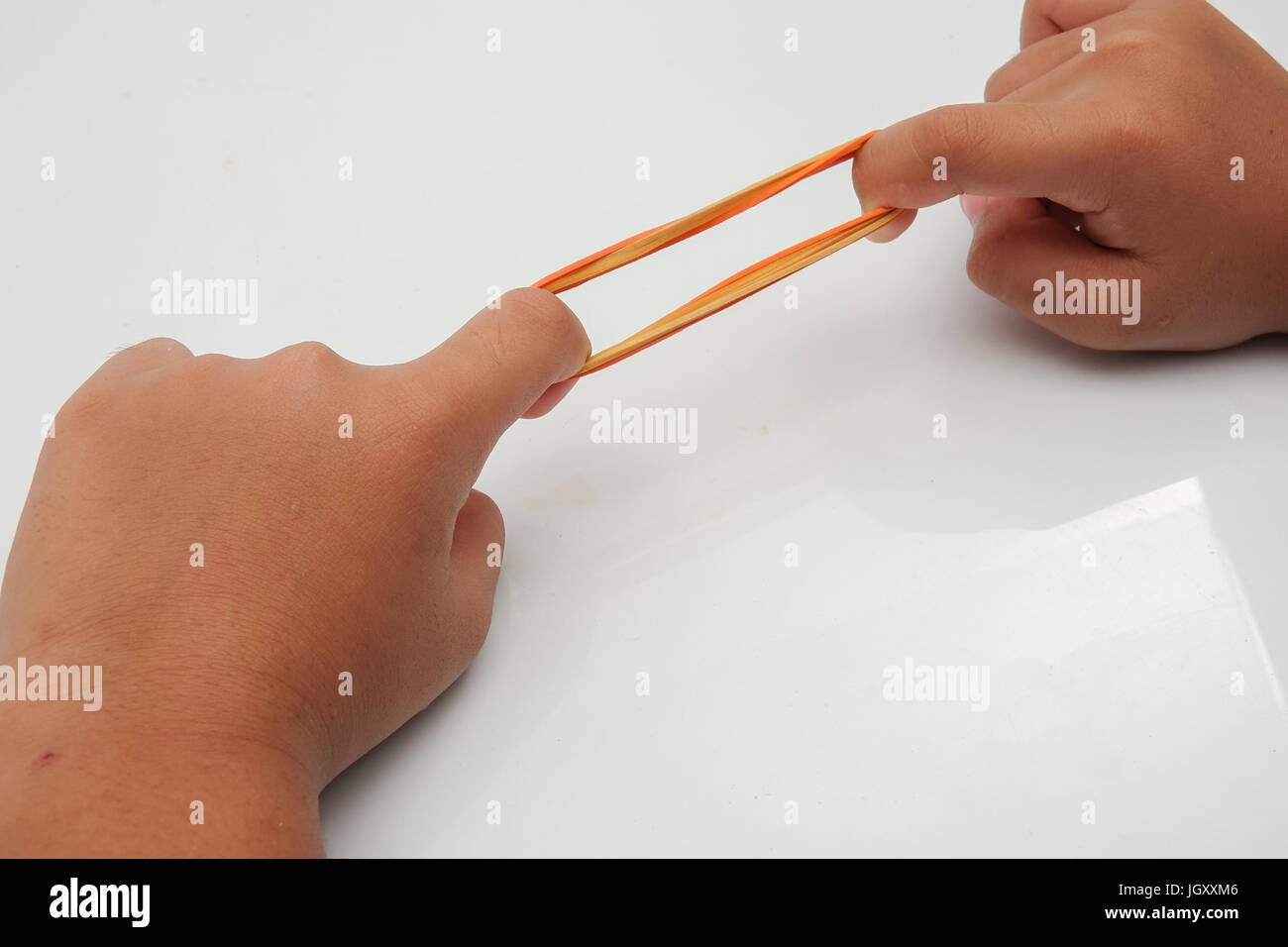 Elastic rubber band on hands, isolated on white Stock Photo - Alamy