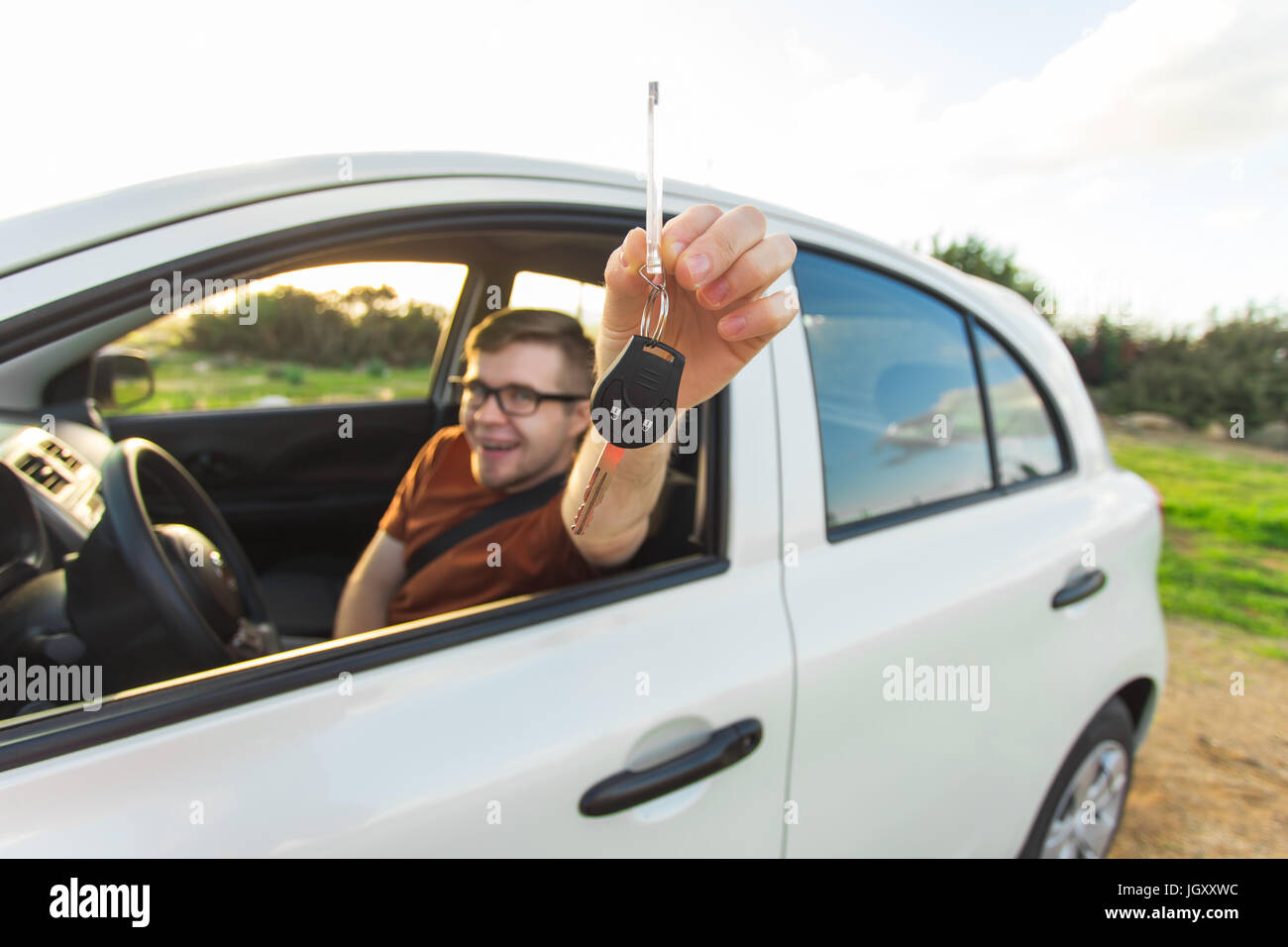 Attractive young happy man showing his new car keys and laughing Stock ...