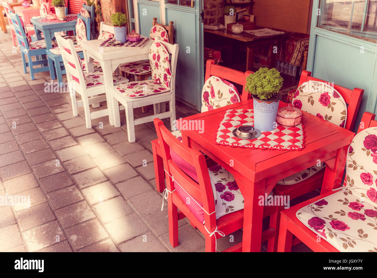 Retro, vintage view of Pastel coffee shop with wooden tables and chairs ...