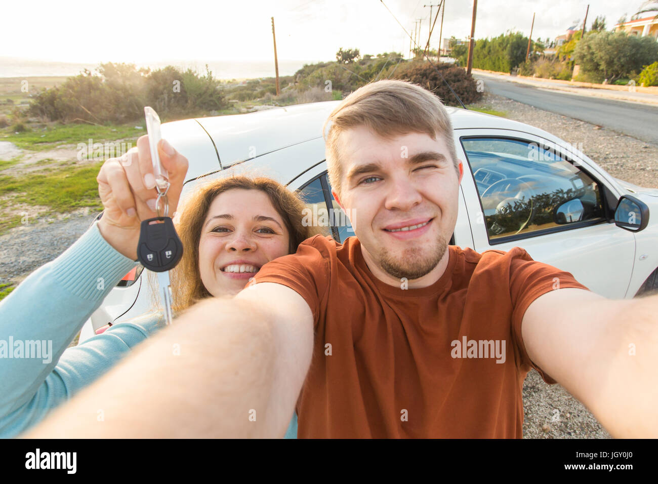 Young funny couple with keys to new car outdoor Stock Photo - Alamy