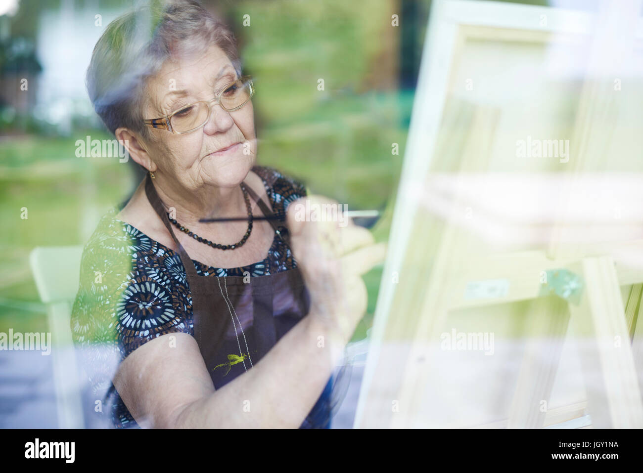 Senior woman wearing eyeglasses holding hi-res stock photography and ...