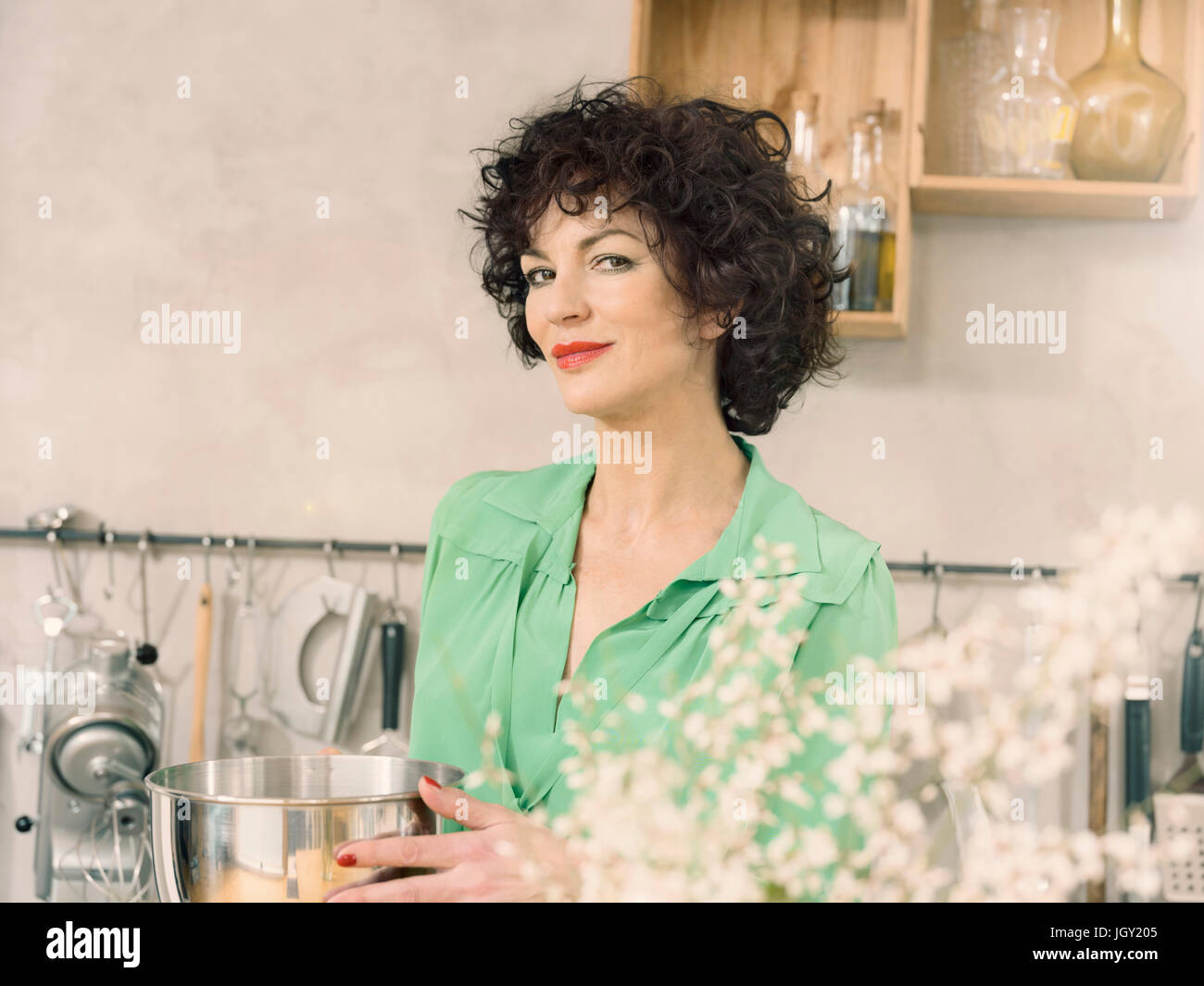 Portrait of woman in kitchen at camera smiling Stock Photo - Alamy