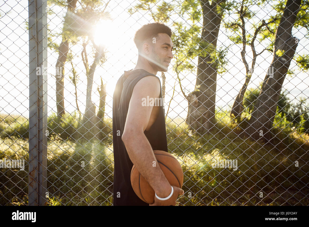 Young man holding basketball Stock Photo - Alamy Young man holding basketball Stock Photo - Alamy