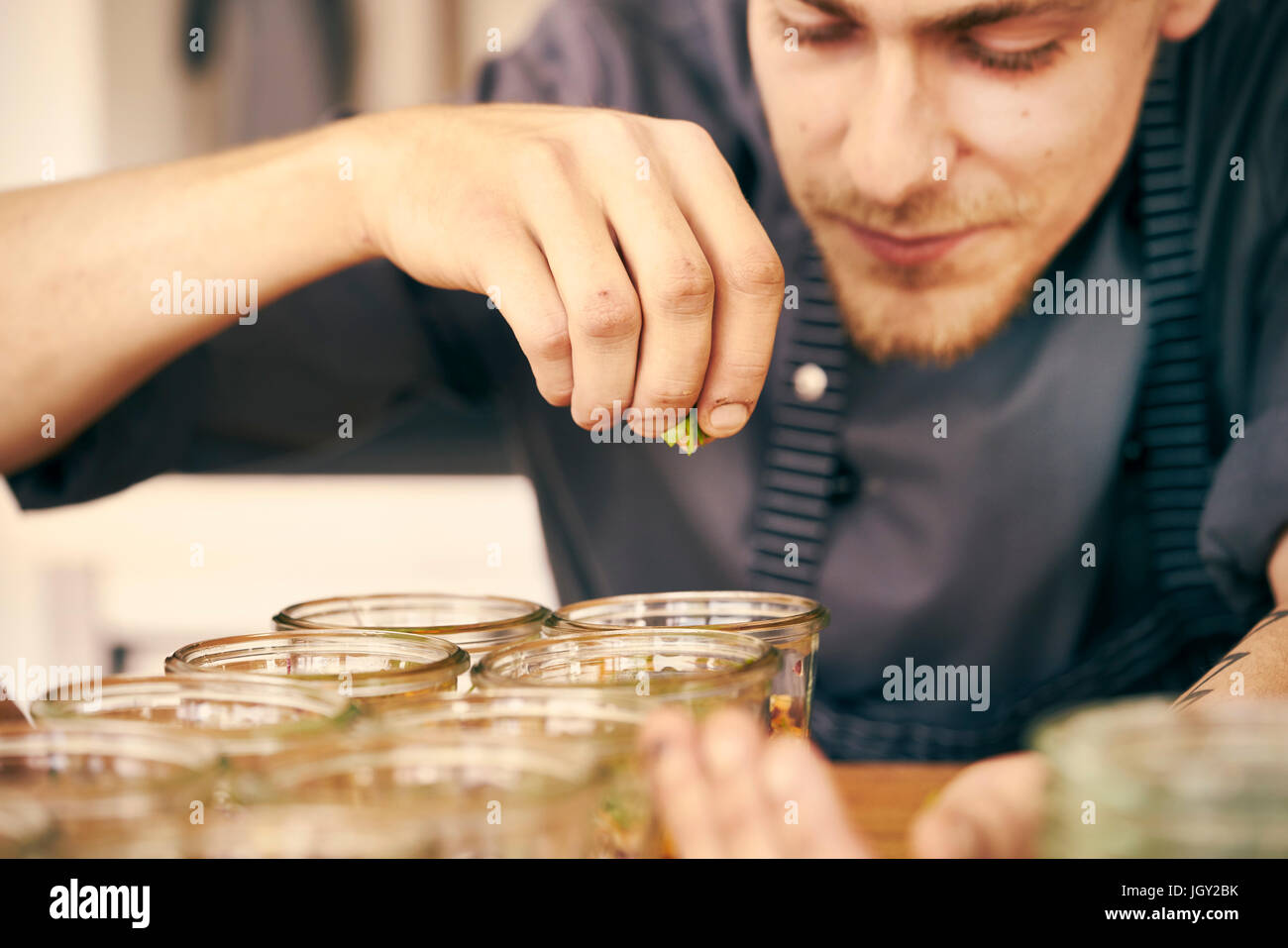 Chef seasoning food in plastic containers Stock Photo - Alamy