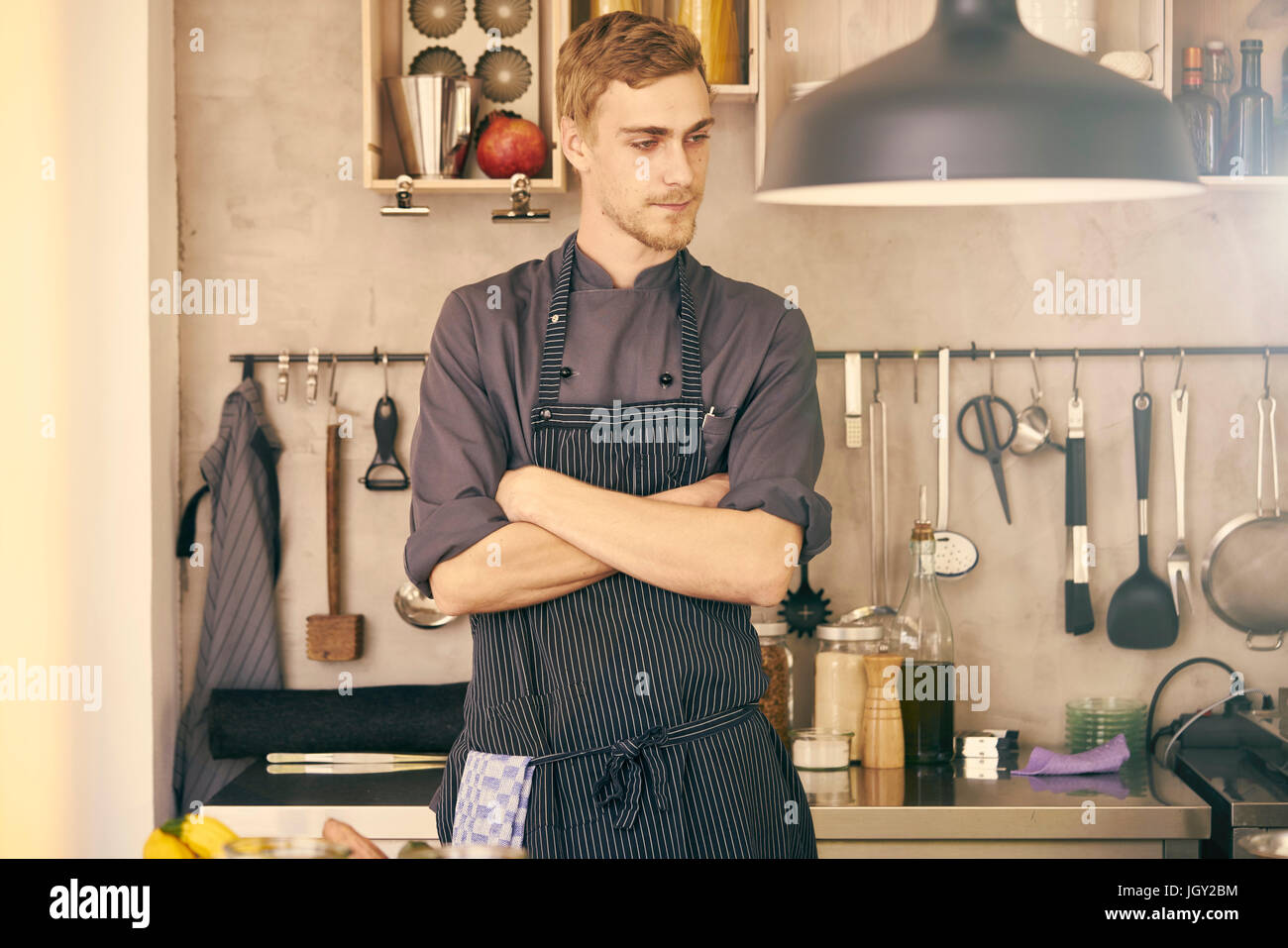 Portrait of chef, arms crossed, looking away Stock Photo - Alamy