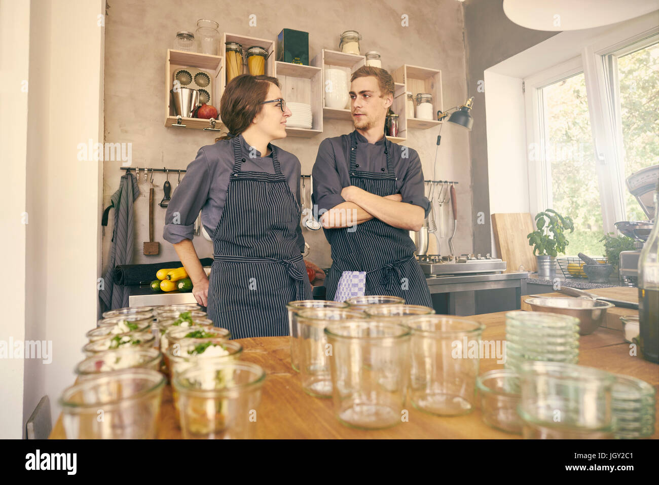 Chefs in kitchen chatting Stock Photo - Alamy