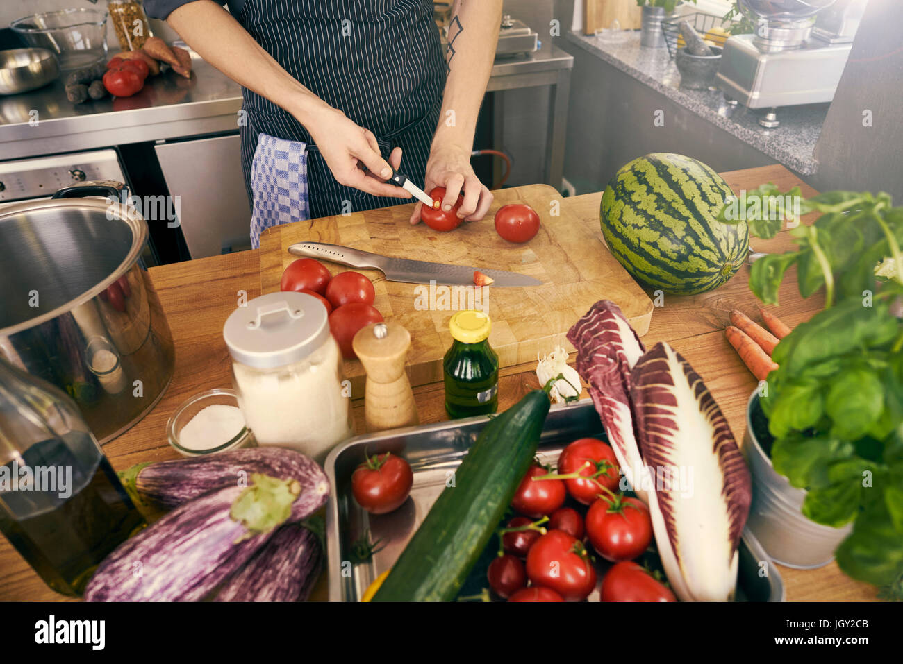 Cropped view of chef chopping tomatoes Stock Photo - Alamy
