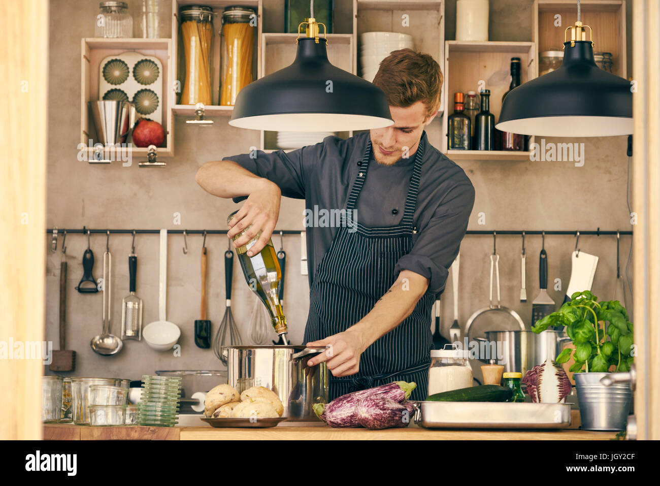 Chef cooking in commercial kitchen Stock Photo - Alamy